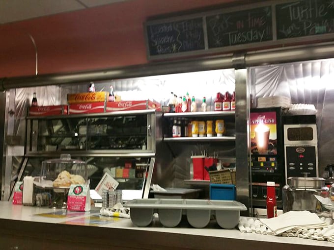 Behind the counter, the organized chaos of a diner kitchen—where magic happens on griddles and short-order cooks perform their daily ballet.
