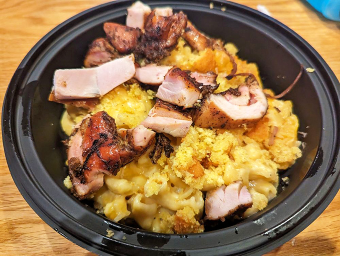 Mac and cheese achieving its highest purpose—as a foundation for smoky, tender pork. Comfort food gets an advanced degree in flavor.