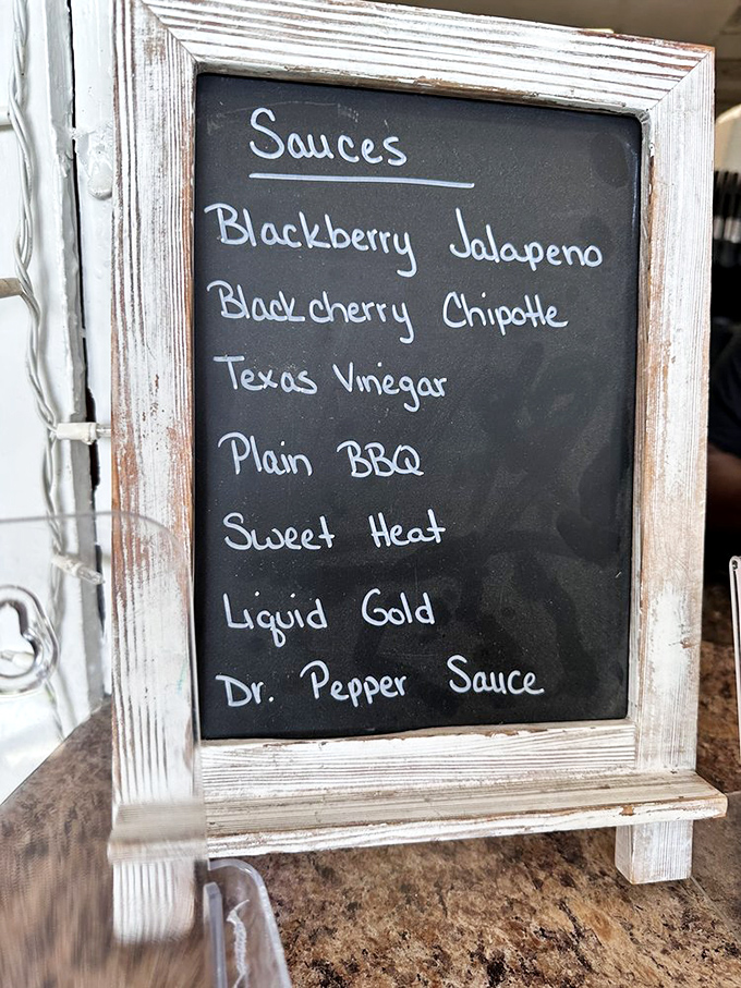 The sauce board reads like poetry: Blackberry Jalapeño, Texas Vinegar, Liquid Gold. Six paths to flavor enlightenment, but the meat stands strong alone.