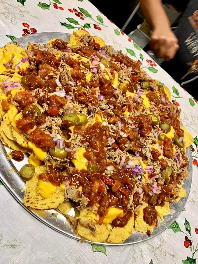 Nachos that don't know when to quit—loaded with pulled pork, cheese sauce, and enough toppings to make sharing mandatory but regrettable.