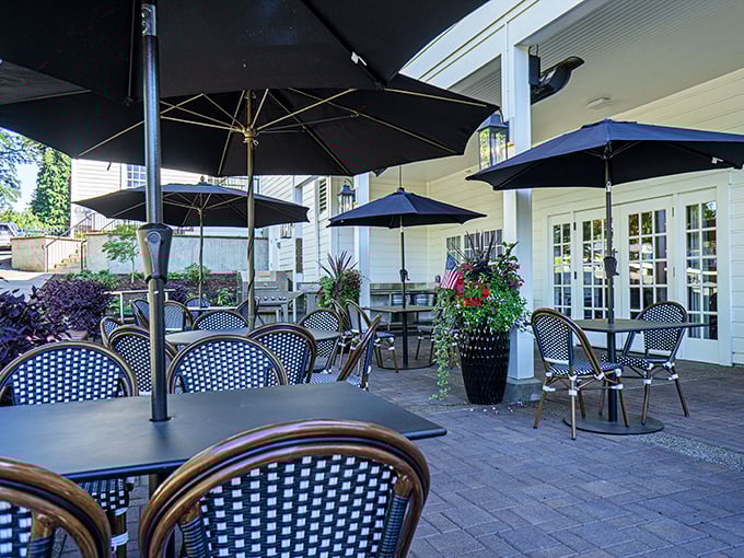 Outdoor seating that captures Oregon's fair-weather magic – blue umbrellas and bistro chairs create a European café vibe in the heart of Aurora.