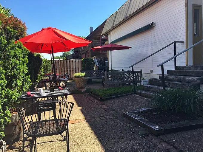Red umbrellas create an outdoor oasis where summer meals taste even better under Virginia's big blue sky.
