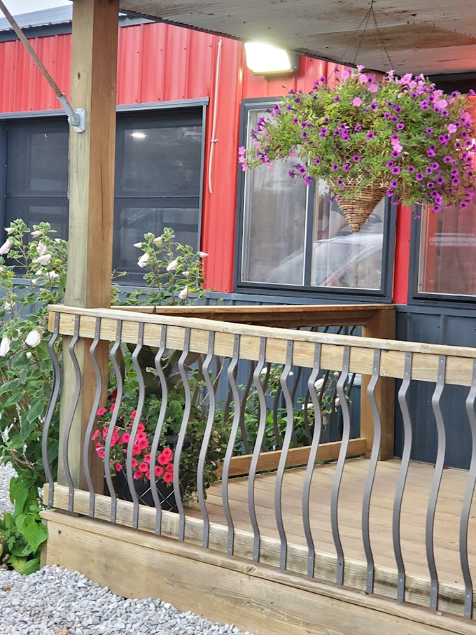 Hanging flower baskets and wooden railings add touches of warmth to the porch – your first hint that attention to detail extends beyond the kitchen.