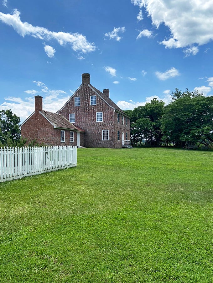 The historic Rackliff House stands as a testament to colonial craftsmanship, its brick exterior having weathered centuries with more grace than most of us manage a decade.