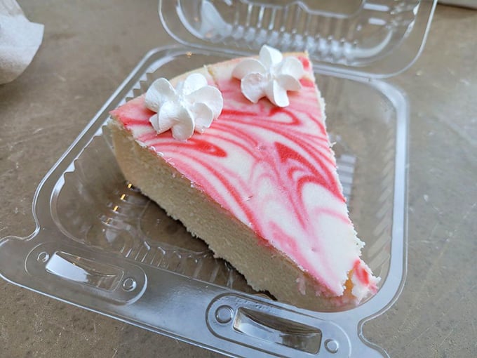 This raspberry swirl cheesecake with delicate cream dollops isn't just pretty—it's the dessert equivalent of finding money in an old jacket pocket.