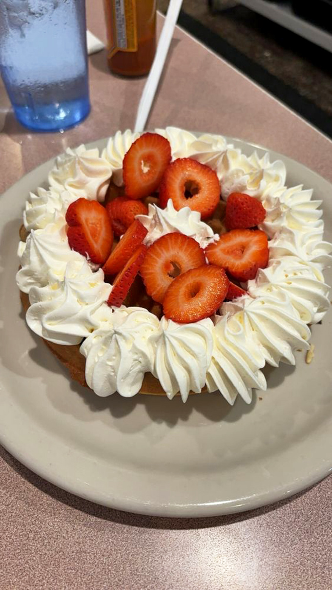 Not a dessert, but a celebration – fresh strawberries nestled in whipped cream that's performing a delicate balancing act between decadence and restraint.