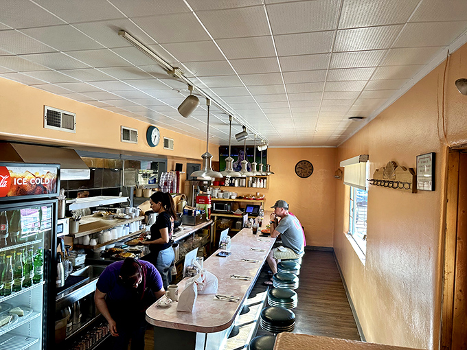 Where the magic happens—the counter view offers a front-row seat to the choreographed chaos of short-order cooking.