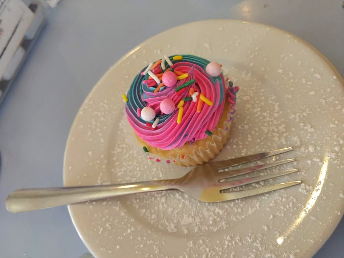 A cupcake that doesn't know the meaning of subtlety. Those sprinkles aren't just toppings—they're tiny confetti celebrating your excellent dessert choice.