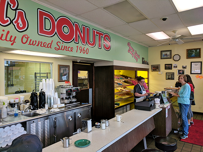 Where morning dreams come true. The yellow glow of the display case illuminates possibilities that chain coffee shops can only imagine.