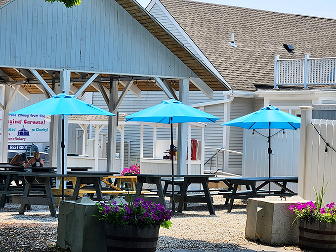 The outdoor seating area, with cheerful blue umbrellas and flower barrels, makes summer lunches feel like a mini-vacation, even for locals.