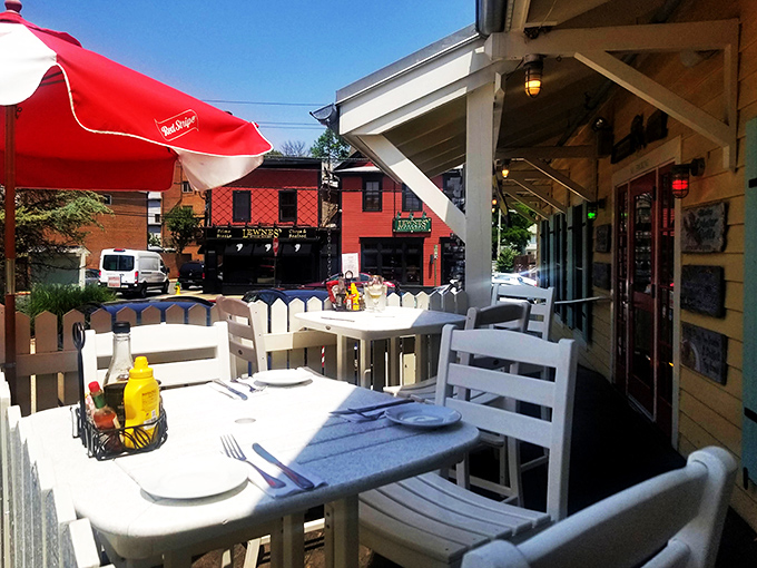Outdoor dining that captures Annapolis's charm—white picket fences, red umbrellas, and the anticipation of seafood that was swimming yesterday.