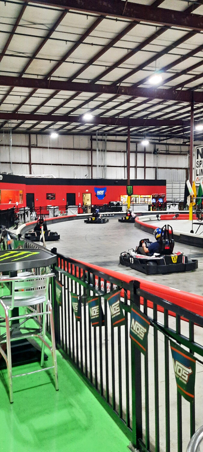 "Just one more lap" faces in their natural habitat. The concentration is palpable—like chess players, but with horsepower instead of pawns.