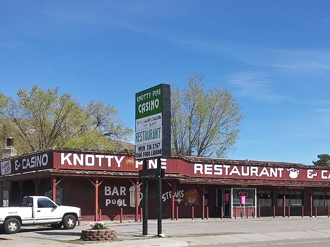 No neon needed—just weathered wood and straightforward signage announcing steaks, pool, and the simple pleasures of small-town Nevada.