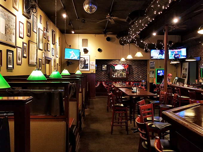 Green-shaded lamps cast a warm glow over wooden booths – creating an atmosphere where strangers become friends and friends become regulars.
