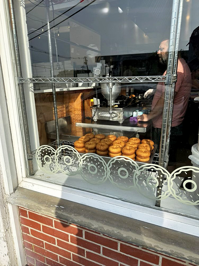 Fresh batches visible through the window – a delicious tease for those waiting outside. Like watching a Broadway show from the sidewalk.