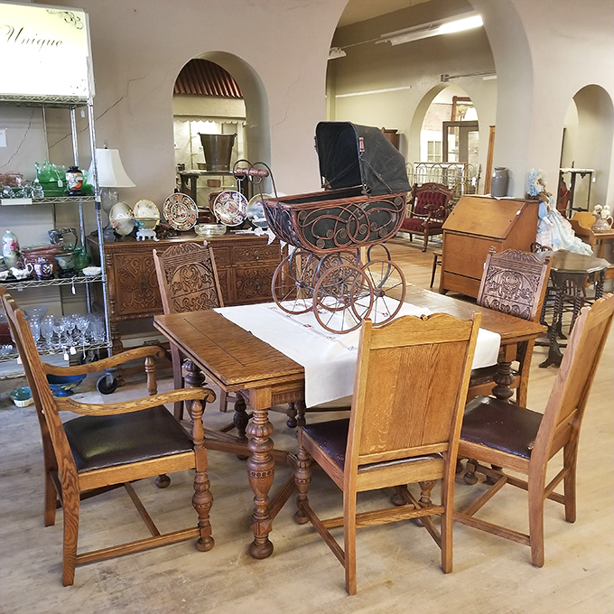 A dining tableau that screams "Sunday dinner at Grandma's"—complete with vintage baby carriage that probably rolled through Ponca City streets decades ago.
