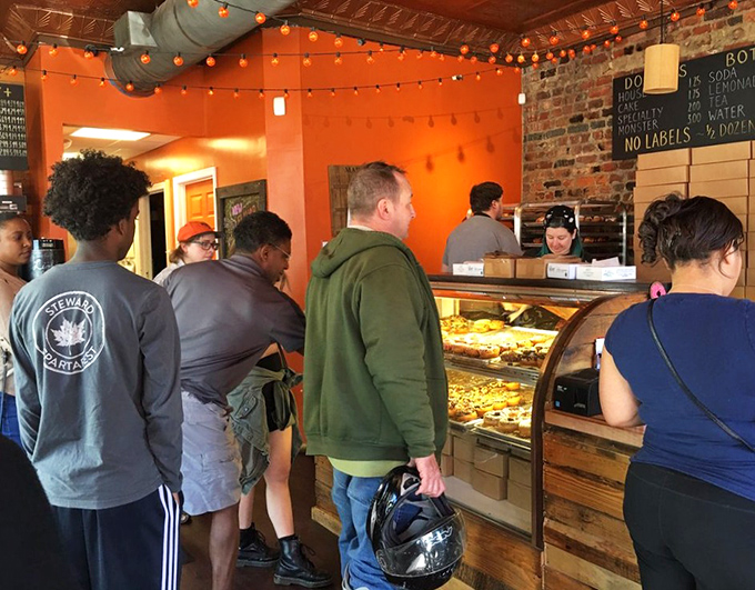 The line forms with purpose—these donut pilgrims know that patience yields sweet rewards. Worth every minute of the wait.