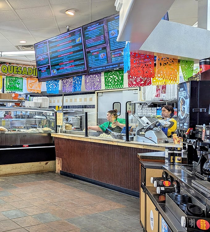 The kitchen crew orchestrates a symphony of flavors with practiced precision, turning humble ingredients into edible masterpieces without missing a beat.