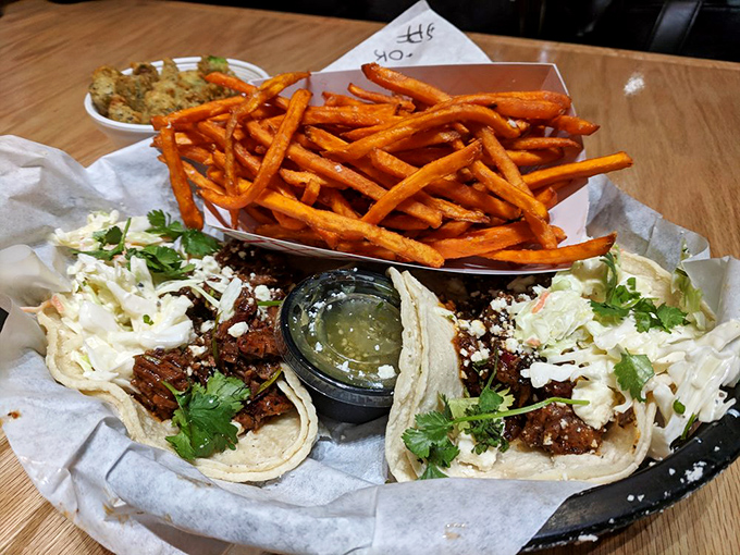 Barbecue breaks free from traditional formats. These tacos prove smoked meat plays well with others—especially when sweet potato fries join the party.