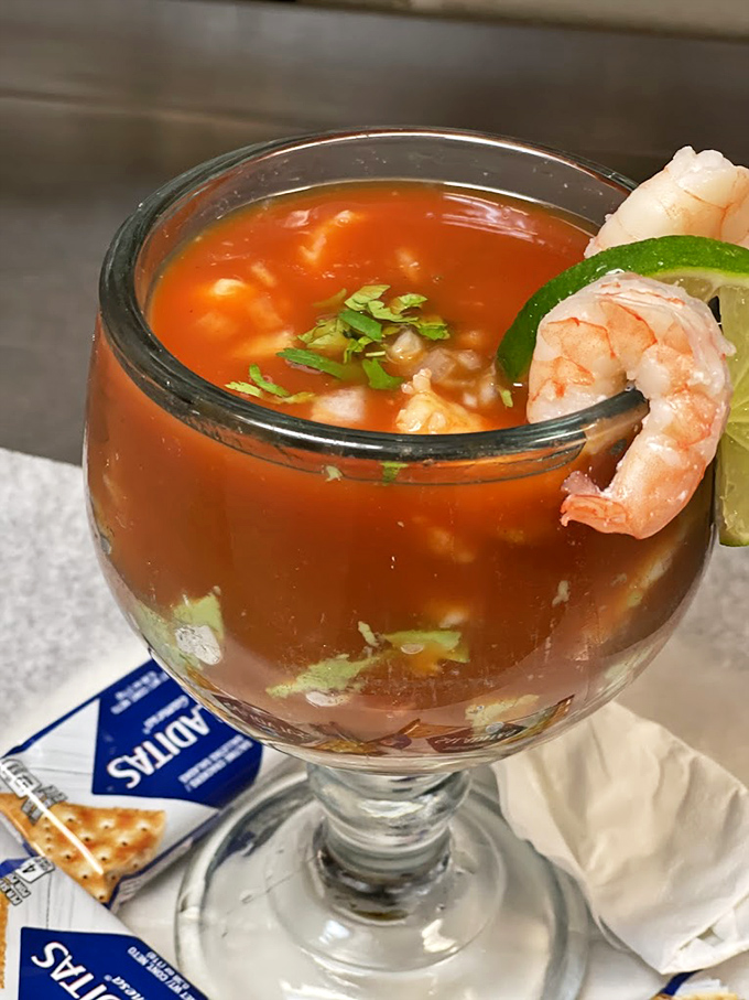 This isn't just a Bloody Mary—it's practically a seafood appetizer. The plump shrimp perched on the rim teases what the kitchen can do with seafood.