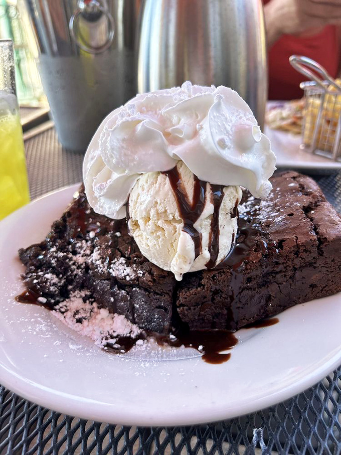 This brownie sundae doesn't just end a meal—it's the grand finale with a standing ovation of vanilla ice cream and whipped cream.