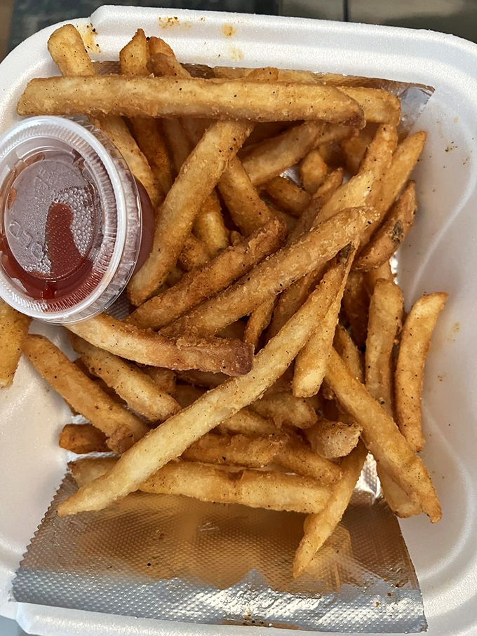 Cajun fries—because regular fries weren't trying hard enough. That little cup of sauce isn't nearly enough for the dipping marathon ahead.