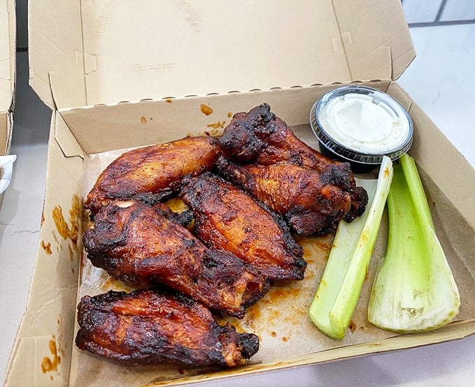 These aren't just wings—they're smoke-kissed flavor bombs that make you wonder why chickens don't just voluntarily fly into barbecue joints.