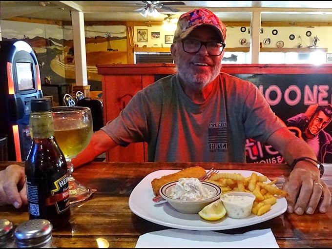 Happy diners and golden-fried goodness—the universal language of roadside satisfaction. That smile says everything about the 50's Road House experience.