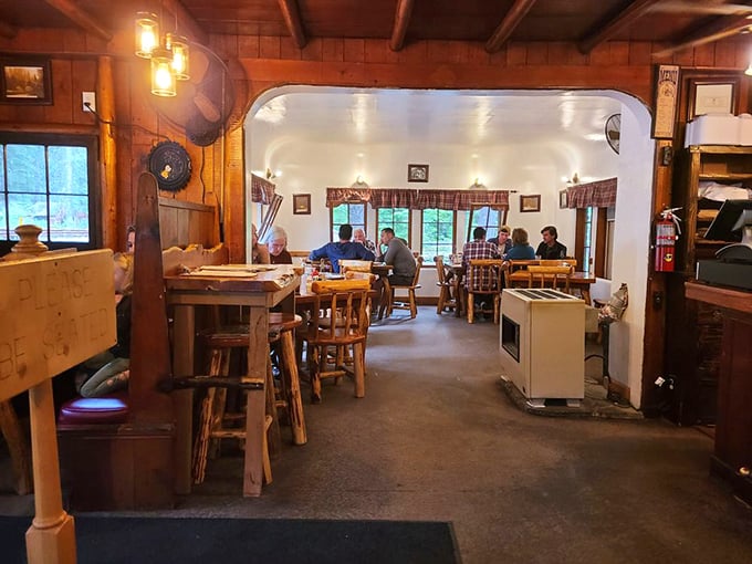 The dining room where strangers become friends over coffee and pie—wooden beams overhead witnessing decades of "just one more bite."