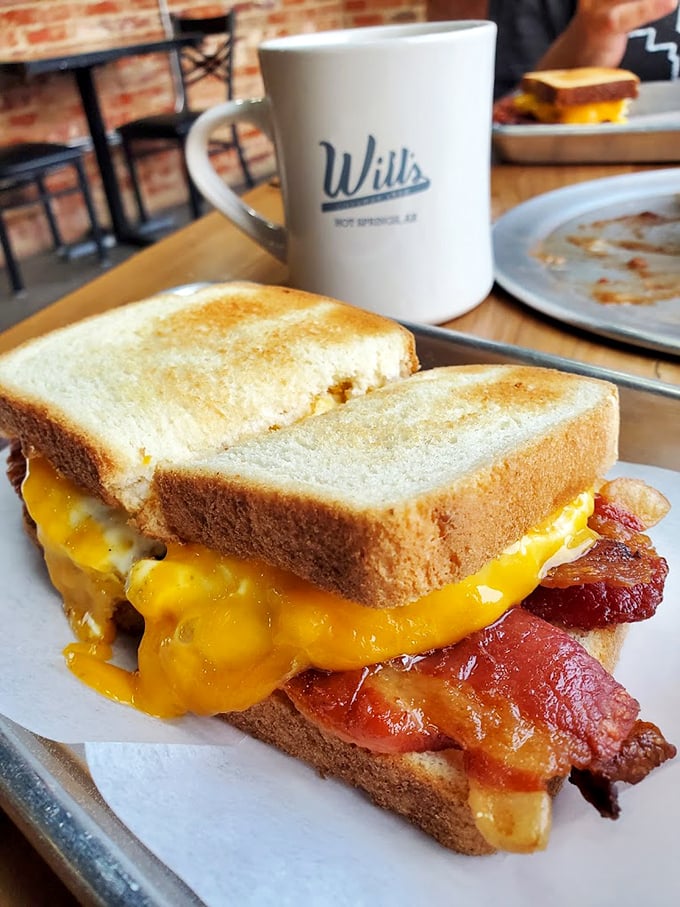 This isn't just a sandwich – it's architecture. Golden toast supporting the perfect balance of melty cheese and crispy bacon in harmonious breakfast bliss.