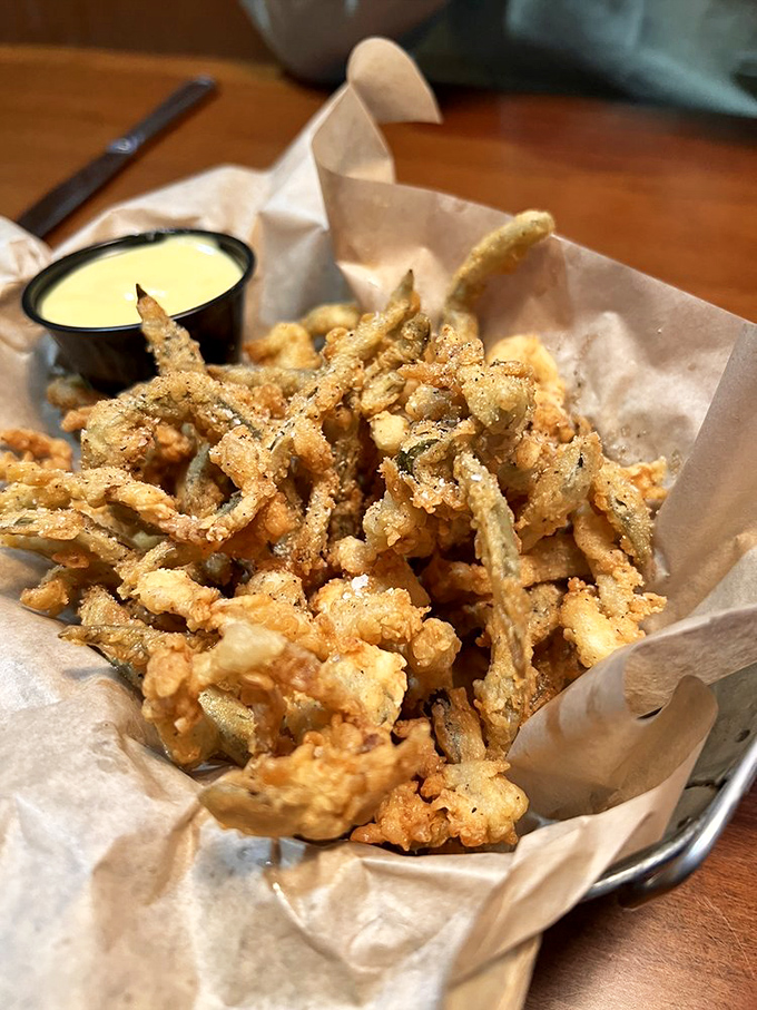 Crispy fried pickles that crunch like autumn leaves, served with a creamy dipping sauce—the appetizer that ruins friendships when the last one disappears.