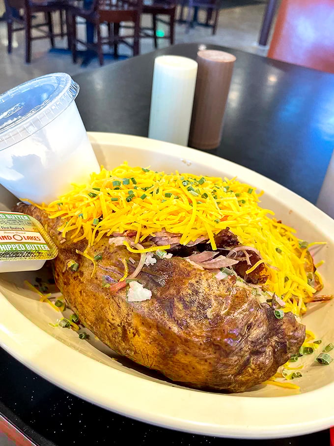 The loaded baked potato that ate Texas—a mountain of spud topped with pulled pork, cheese, and enough calories to fuel a cattle drive.