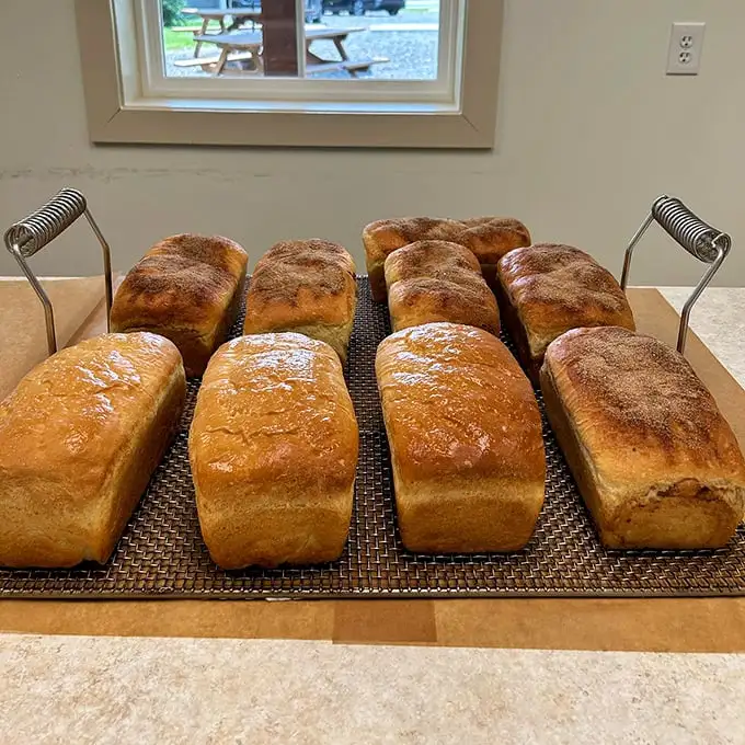 Sourdough loaves cooling on the rack—the bread equivalent of that perfect pillow you can't wait to rest your head on.