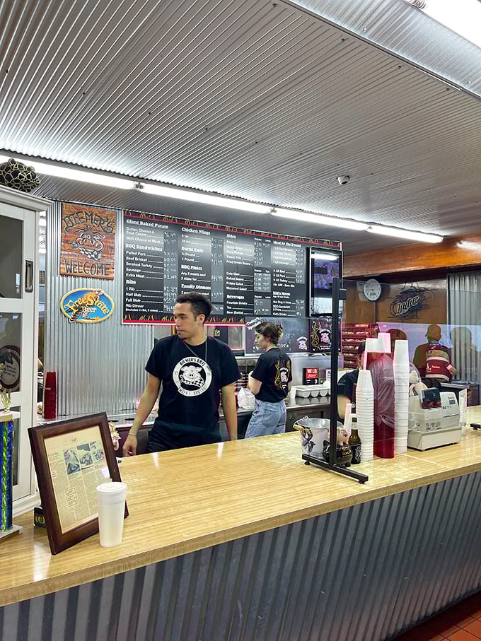 The counter staff at Biemer's—the gatekeepers to smoked meat paradise. Their t-shirts may be black, but their BBQ intentions are pure gold.