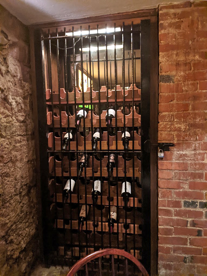 Wine bottles resting behind bars – perhaps the only "inmates" happy to be locked up in this former jailhouse.