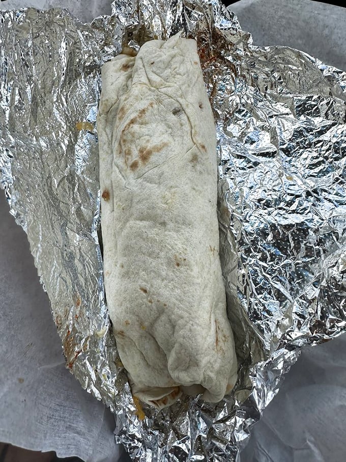 The breakfast burrito in its natural habitat – foil-wrapped perfection that makes morning people out of even the most dedicated night owls.
