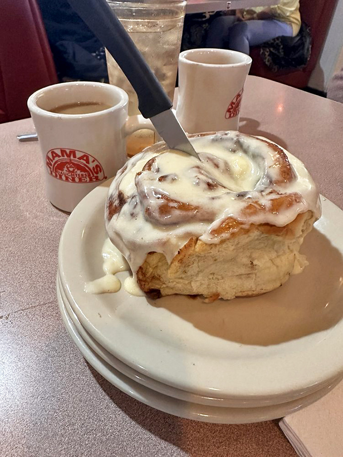 The cinnamon roll isn't just breakfast – it's an event. That knife isn't cutting, it's releasing years of perfected pastry technique.