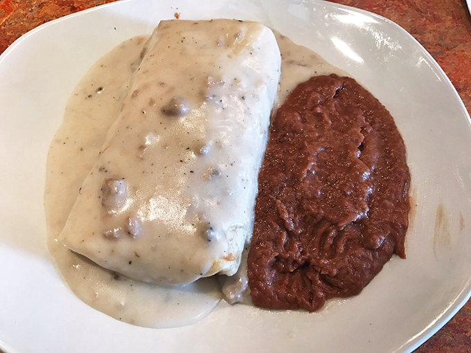 Half burrito, half work of art—this white-and-red sauce duo creates the culinary equivalent of a sunset over the desert, with potatoes as the mountains.