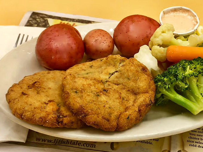 These crab cakes with red potatoes and fresh vegetables prove that sometimes the best plate is one with distinct sections—like TV dinners for grown-ups with taste.