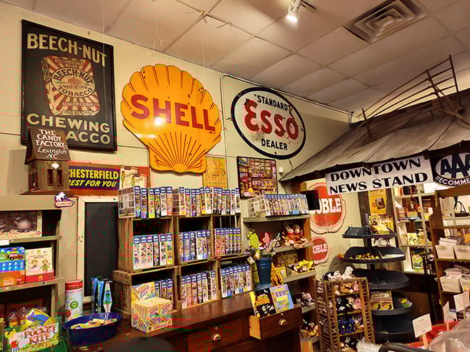 Vintage signs from America's golden age of advertising create a time-capsule effect – Shell and Esso logos watching over jelly beans and gummies.