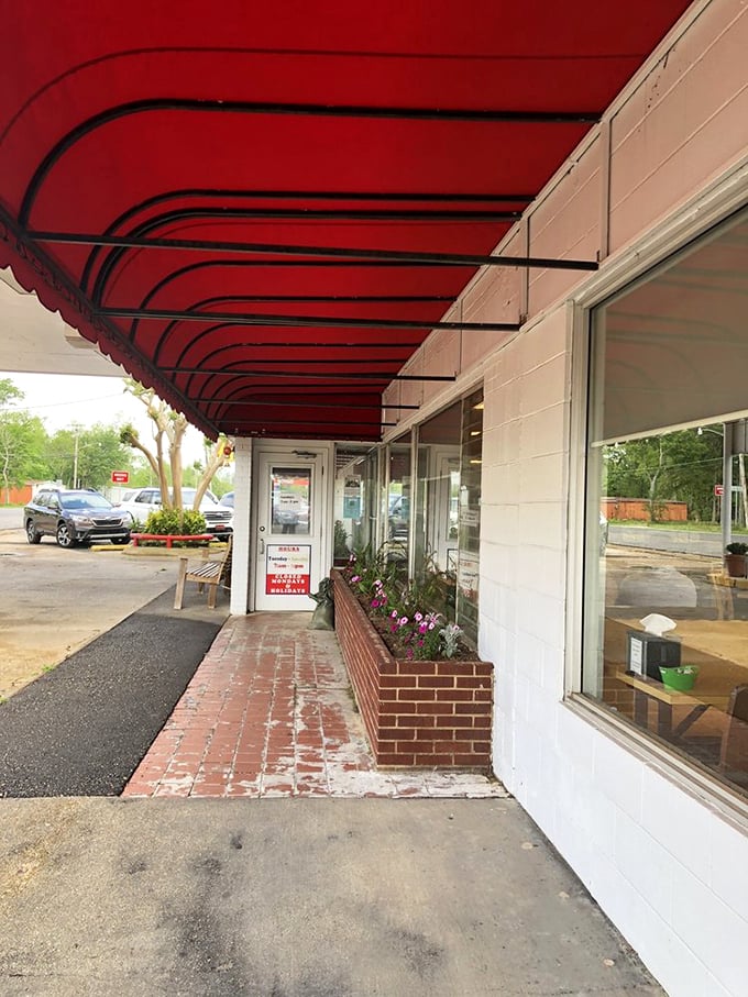 The welcoming entrance with its signature red awning and flower boxes – a portal to pie paradise that's been tempting travelers for generations.