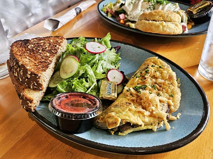 This isn't just an omelette—it's a perfectly executed morning masterpiece with a supporting cast of fresh greens and hearty toast ready for their close-up.