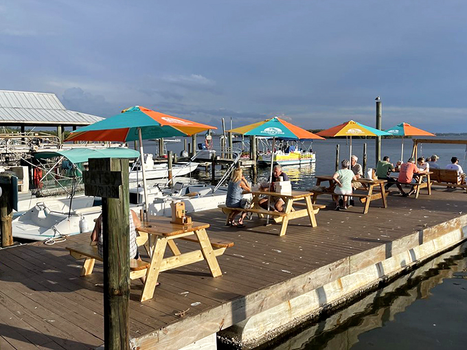 Colorful umbrellas, wooden picnic tables, and water views—the Florida dining room that no interior designer could improve upon.