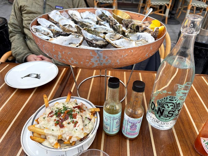 These oysters aren't just served – they're presented like the crown jewels of the ocean, with condiments as their loyal courtiers.