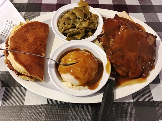 This plate tells Kentucky's comfort food story: roast beef, cornbread, mashed potatoes, and green beans—a quartet playing perfect harmony on your taste buds.