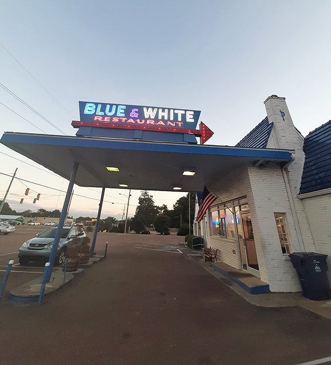 At dusk, that neon sign glows like a Southern firefly. Not all who wander are lost—some are just looking for the Blue & White.