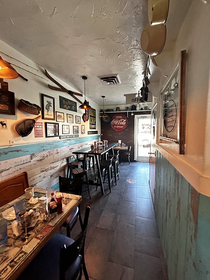 The narrow hallway of nostalgia – where Coca-Cola signs and weathered wood paneling create the perfect atmosphere for coffee and conversation.