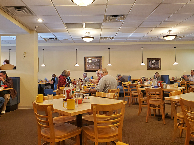 The dining room hums with the satisfaction of people who've made the right breakfast decision—yellow mugs standing ready for coffee refills.