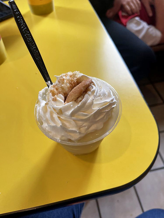 Banana pudding with a cloud of whipped cream. The kind of dessert that makes you seriously consider licking the container when no one's looking.