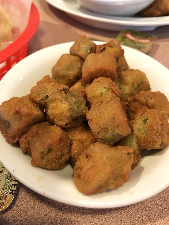 Fried okra – the South's answer to popcorn. These golden nuggets convert vegetable skeptics into true believers one crunchy bite at a time.